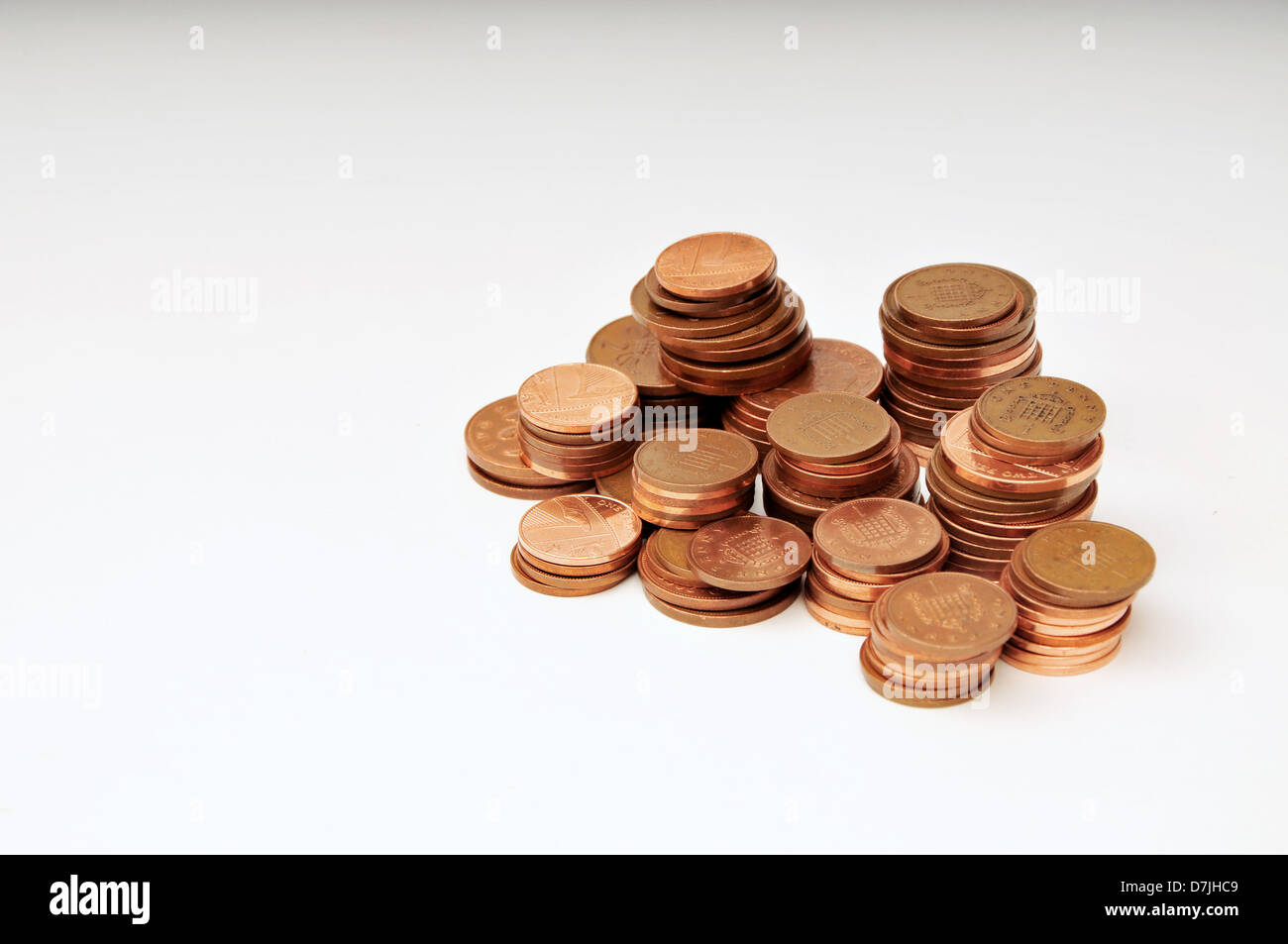 Stacks of British copper coins against a plain background Stock Photo ...