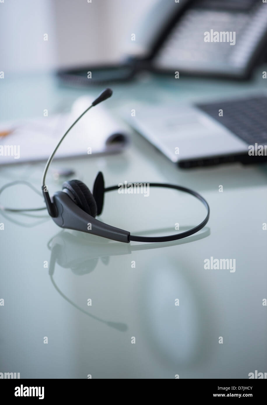 Close-up of headset on desk Stock Photo - Alamy