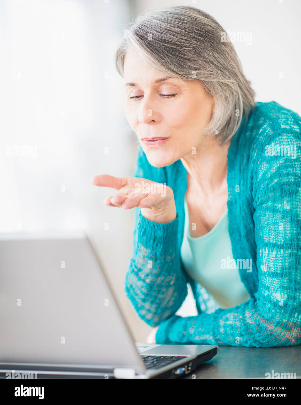 Woman kiss laptop hi-res stock photography and images - Alamy