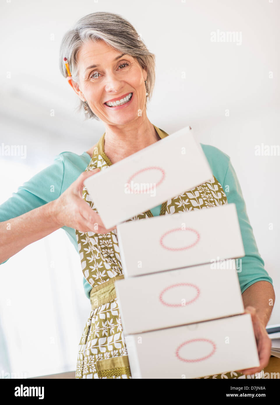 Portrait of woman carrying boxes Stock Photo - Alamy