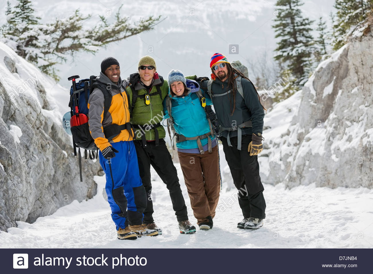 Portrait of group of friends on winter hike in mountains Stock Photo ...