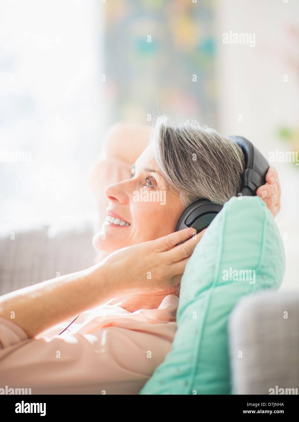 Portrait of woman listening to music Stock Photo - Alamy
