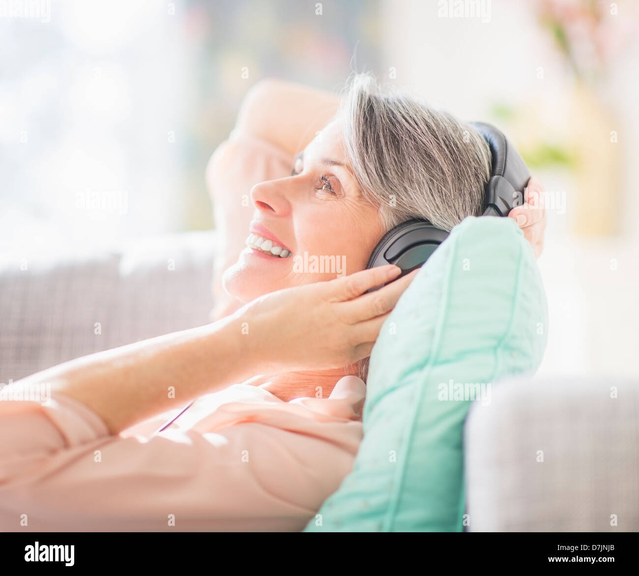 Attractive woman listening music lying hi-res stock photography and ...