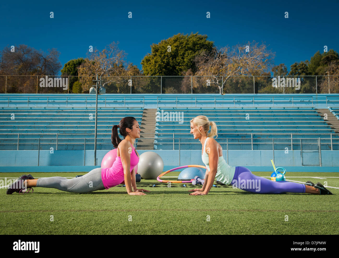 Young women two stretching outdoors exercising hi-res stock photography ...