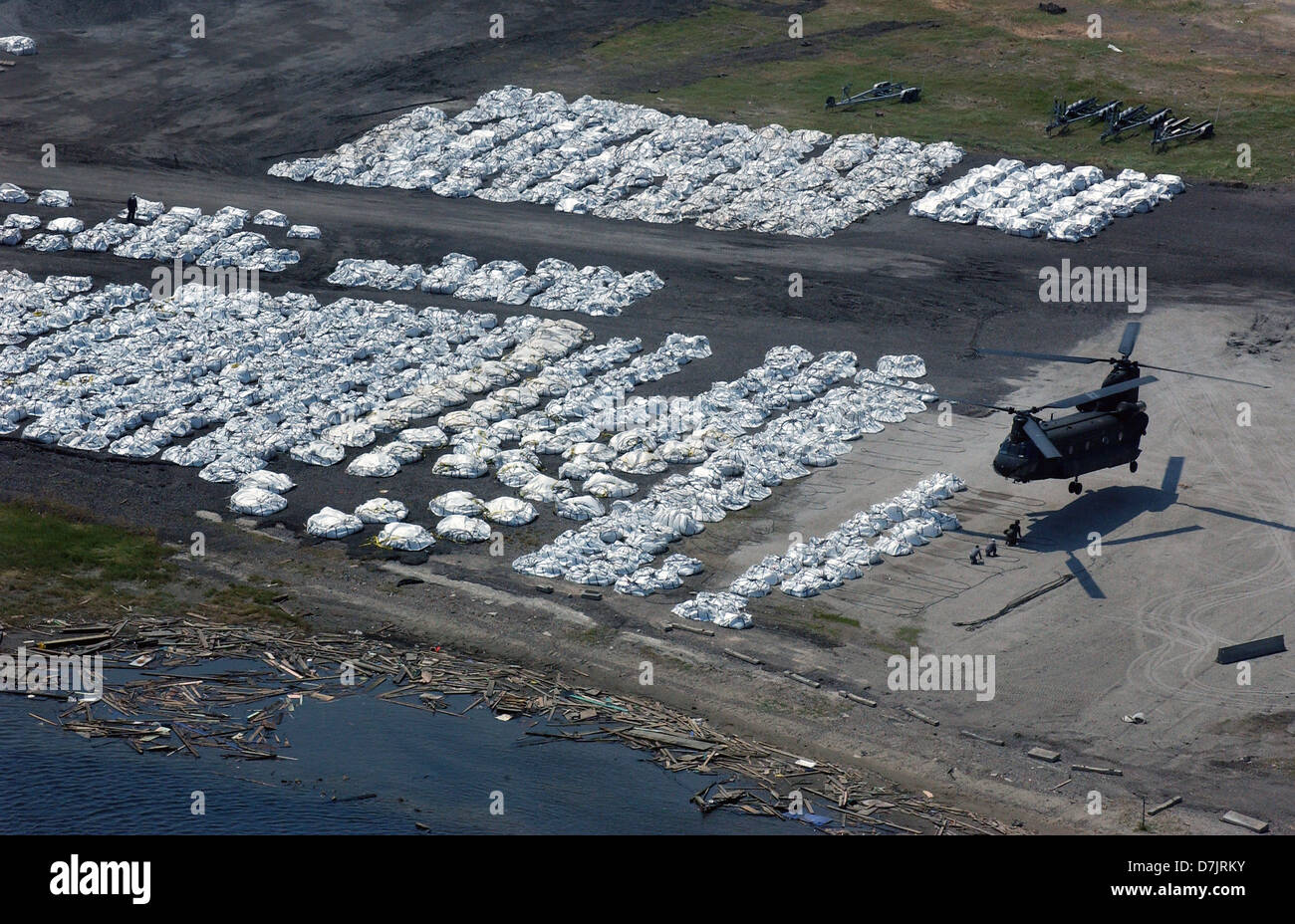 Aerial view of a Chinook helicopter picking up sandbags at a staging ...