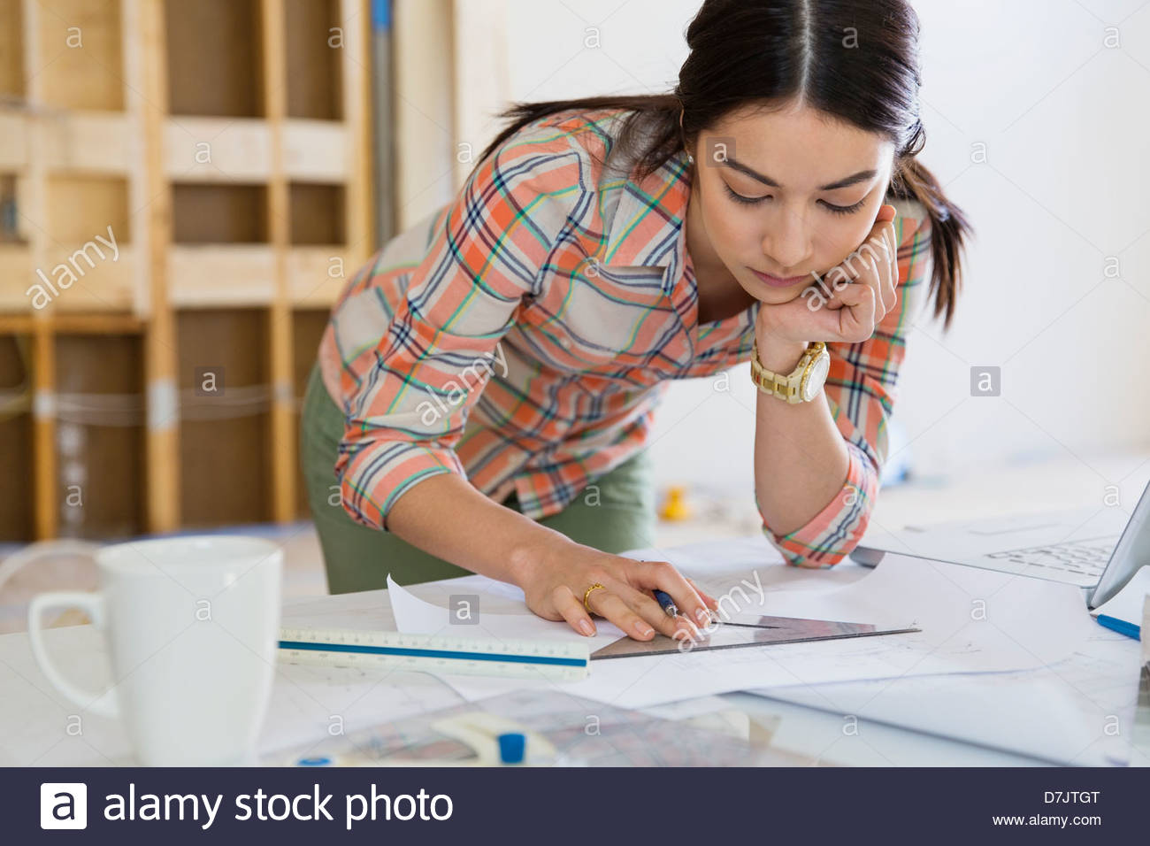 Young woman using set square at table Stock Photo - Alamy