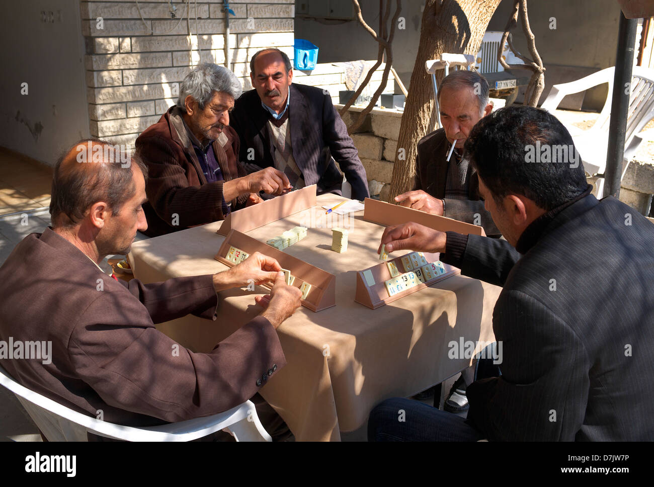 Turkish men playing the tile game of okay, in a back street cafe, Belek ...