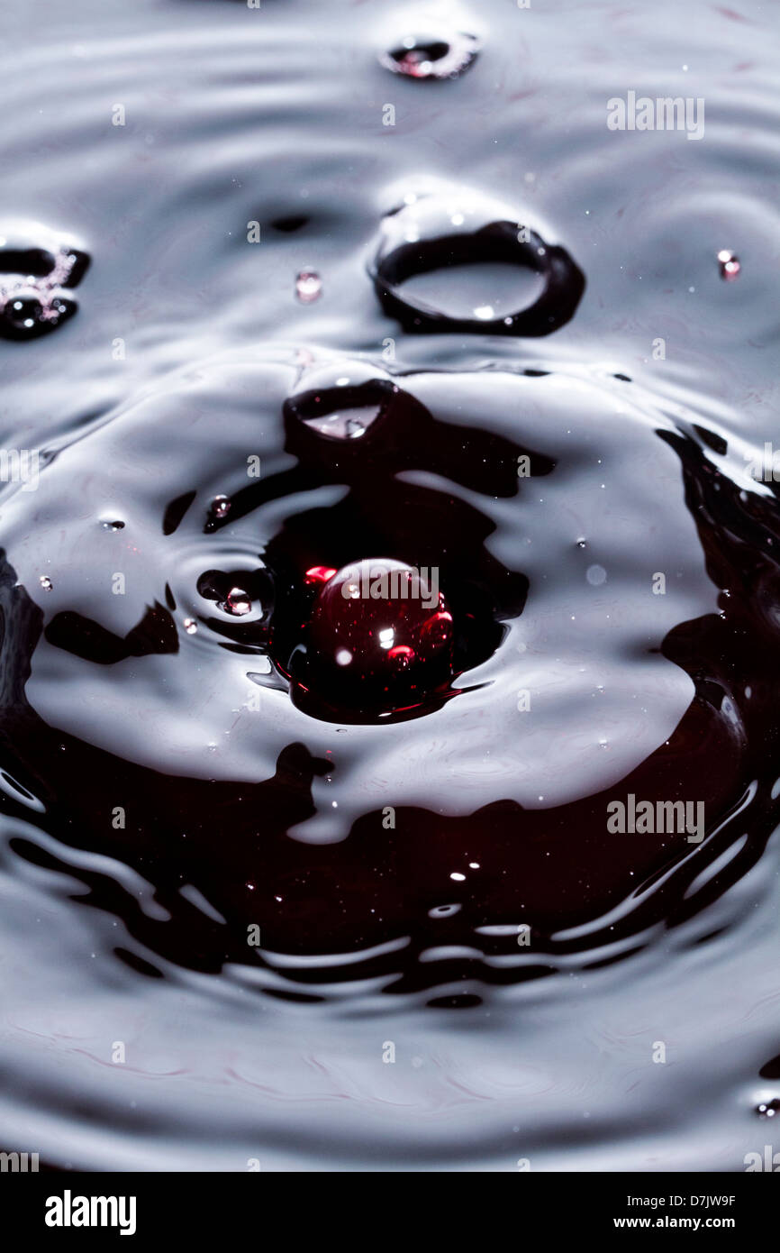 Close view of a droplet of wine hitting a surface of wine Stock Photo ...