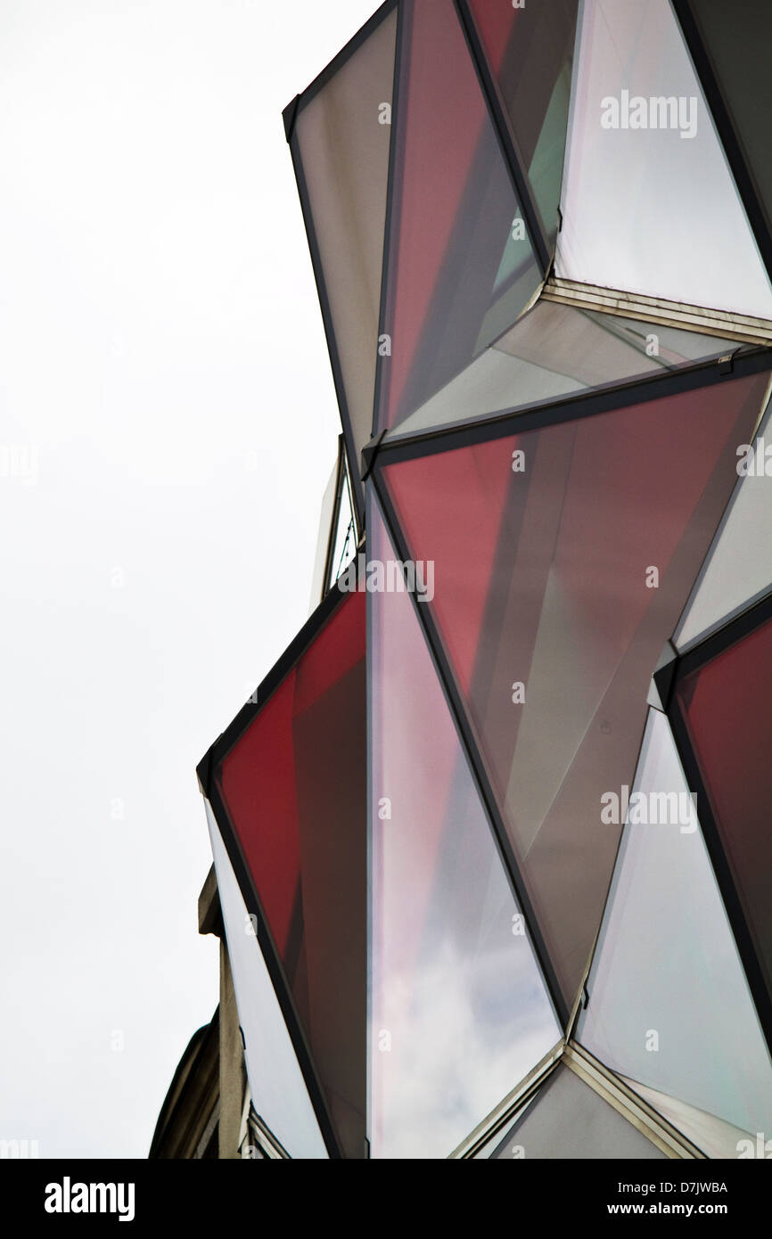 View of a curious modern building with red glass windows Stock Photo ...