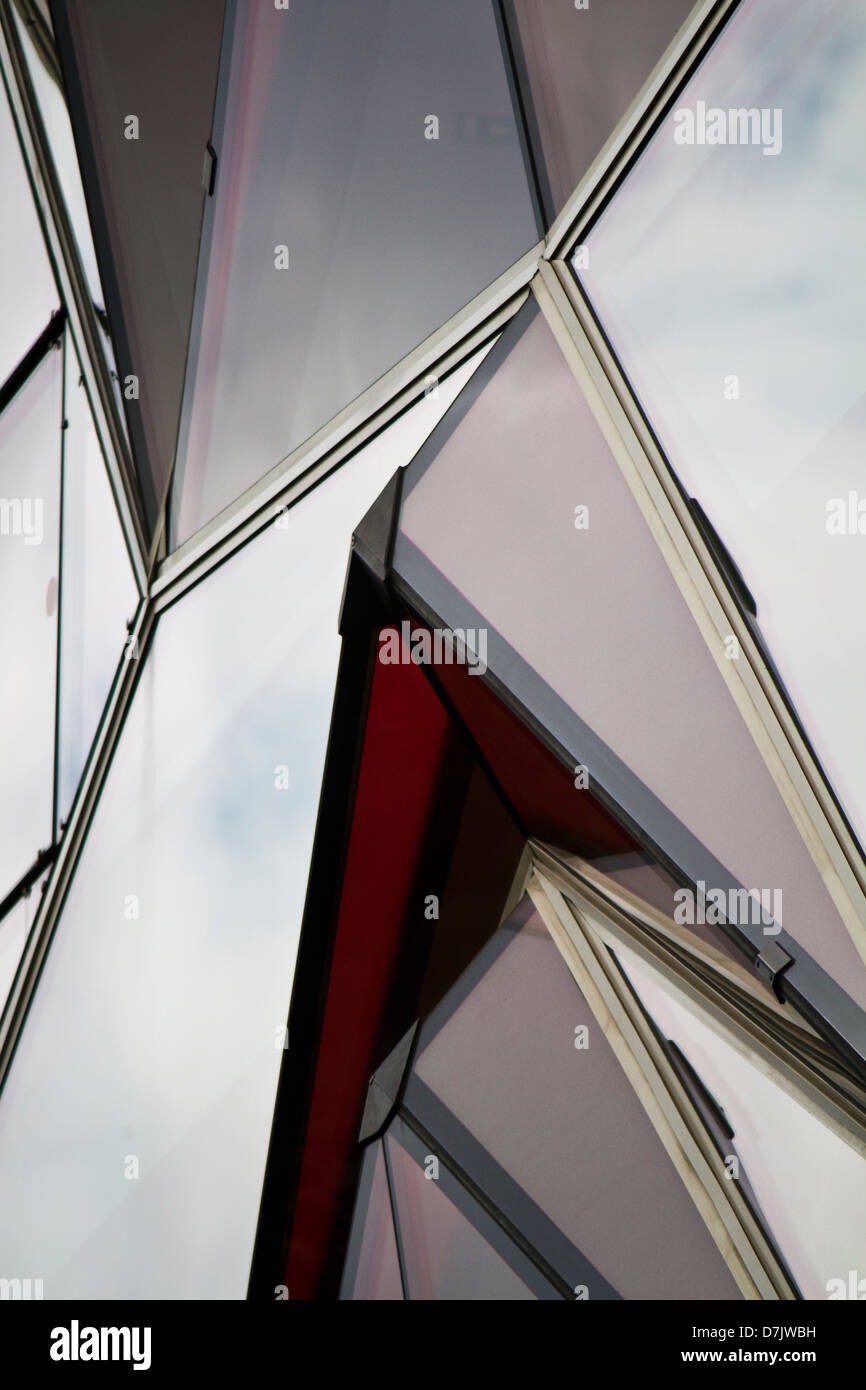 View of a curious modern building with red glass windows Stock Photo ...