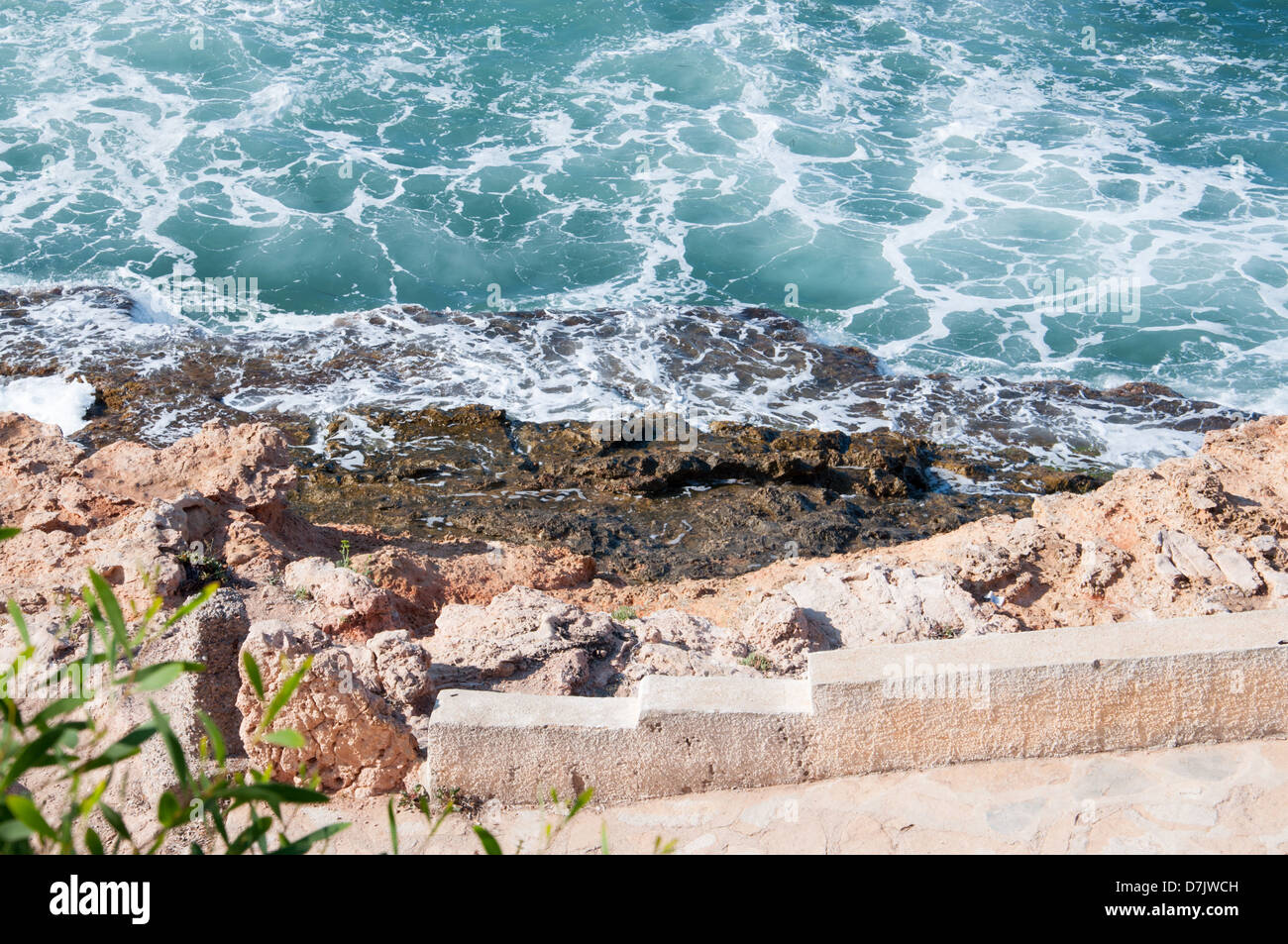 Green foamy water and soft red rocks Stock Photo - Alamy