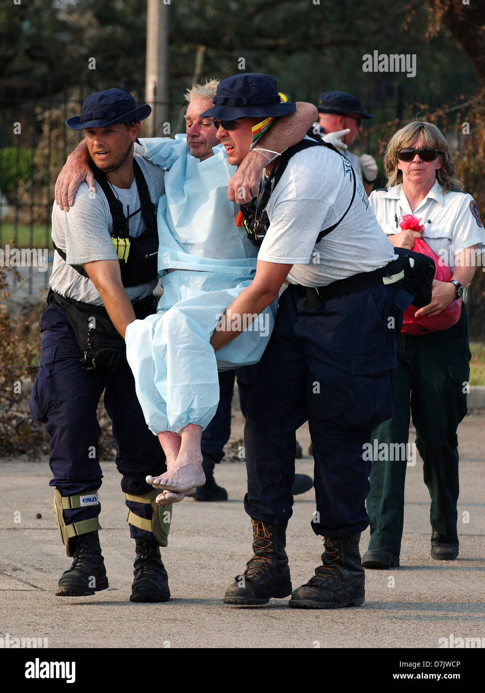 FEMA Urban Search & Rescue teams carry and injured elderly man to an ...