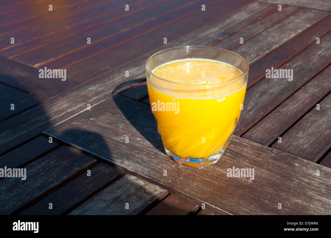 Glass of orange juice on rustic wooden table Stock Photo - Alamy