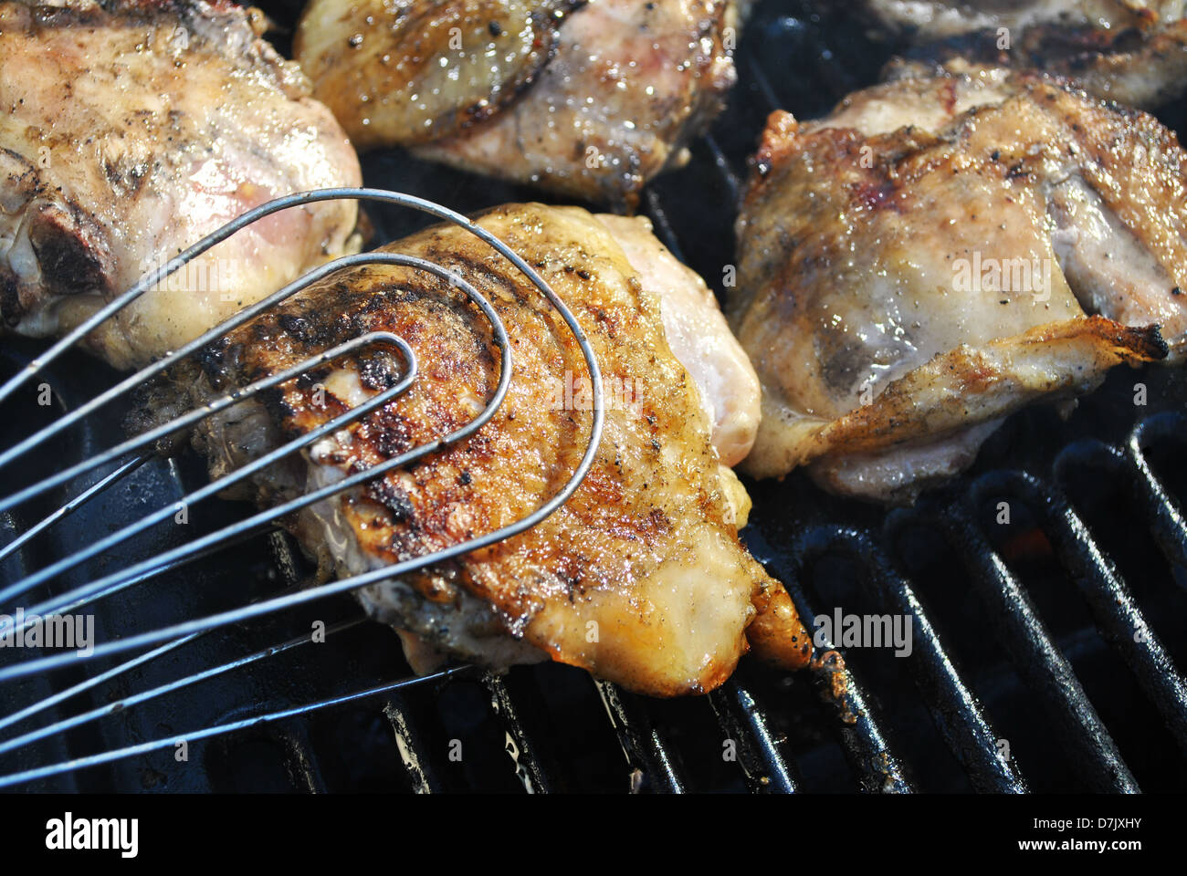 Flipping a Grilled Chicken Thigh Stock Photo - Alamy