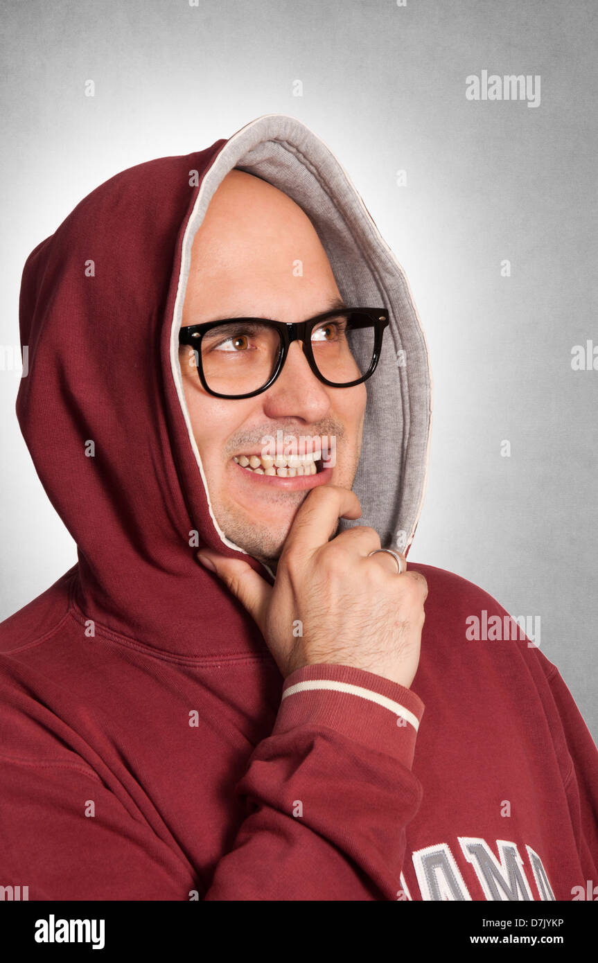 Man with hood on his head have evil thinking smile Stock Photo - Alamy