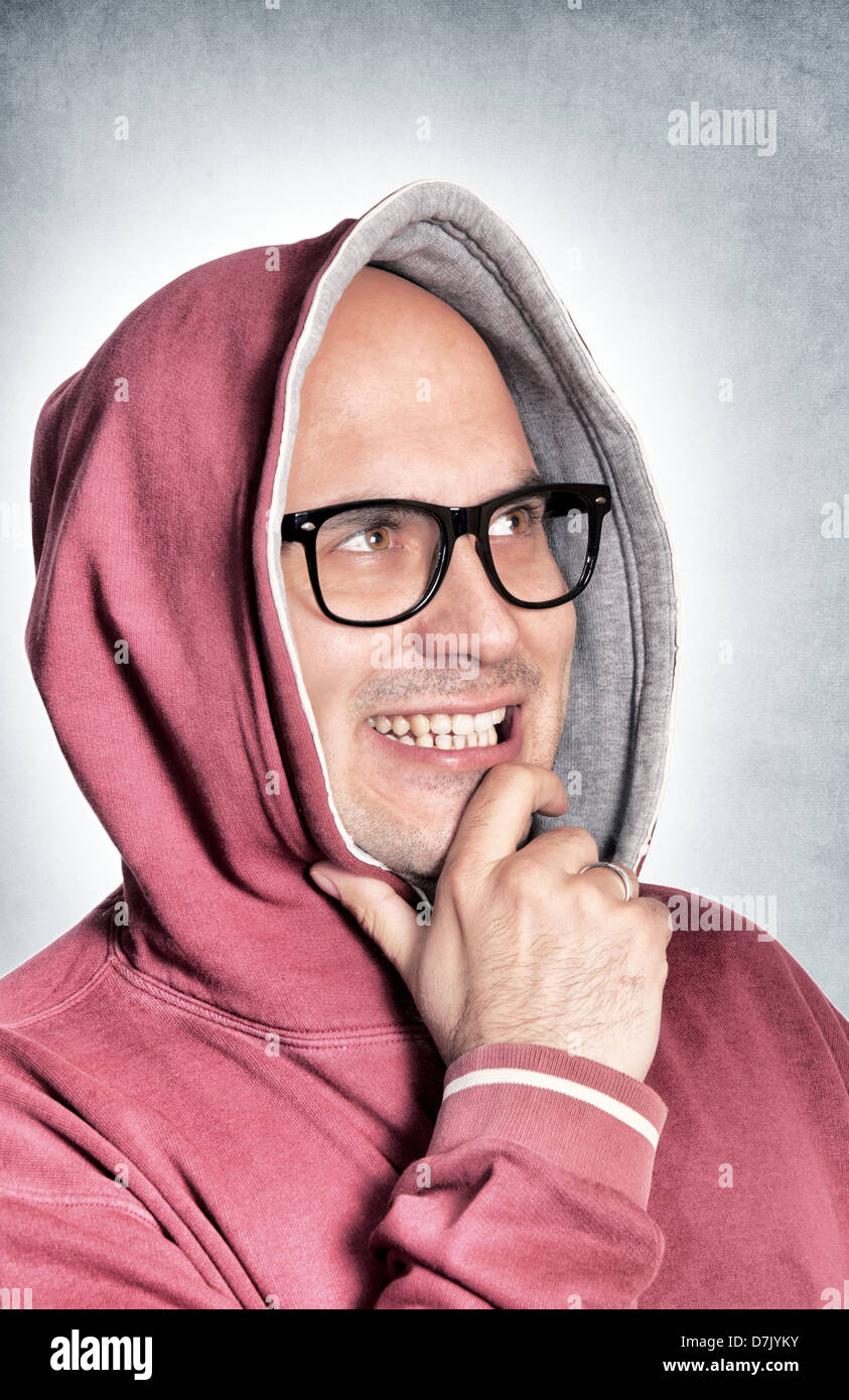 Man with hood on his head have evil thinking smile Stock Photo - Alamy