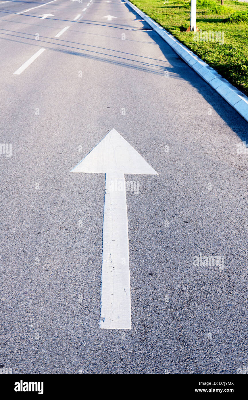 Forward arrow sign on the road Stock Photo - Alamy