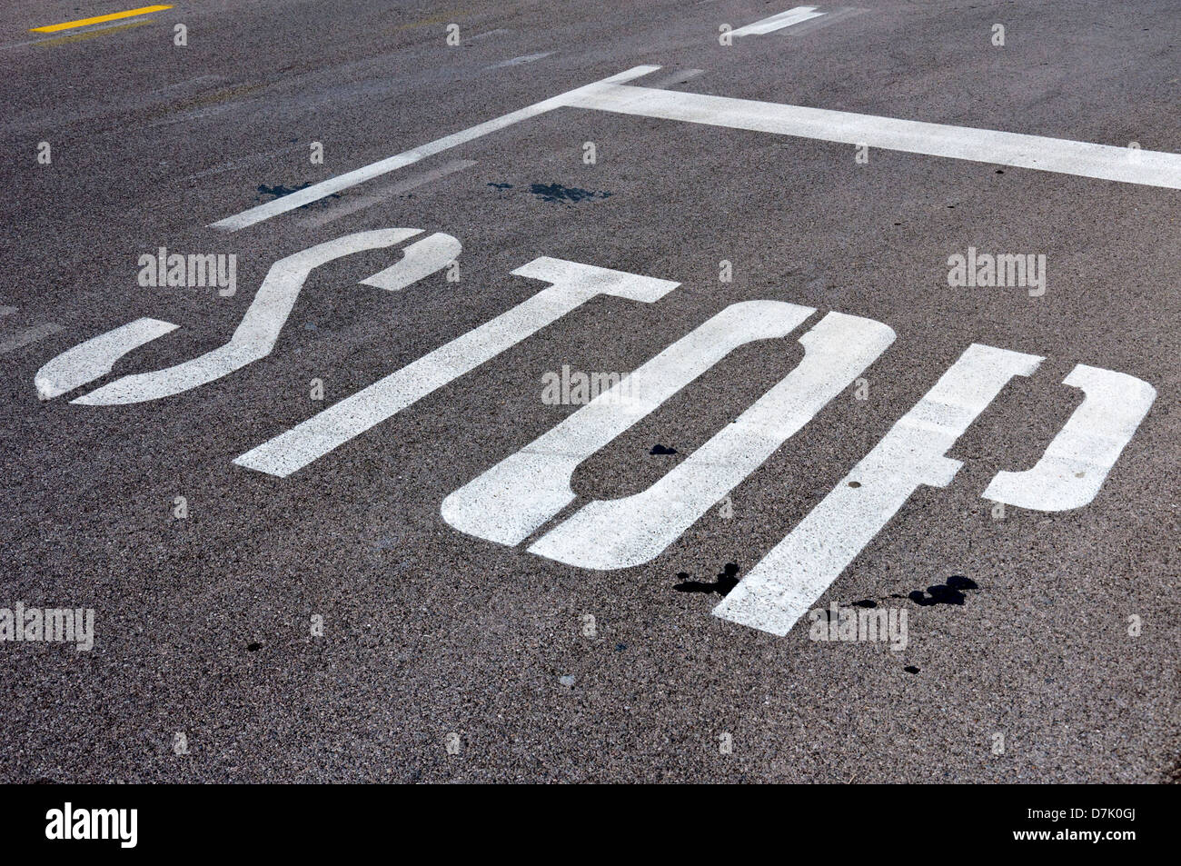 White stop sign on the road Stock Photo - Alamy