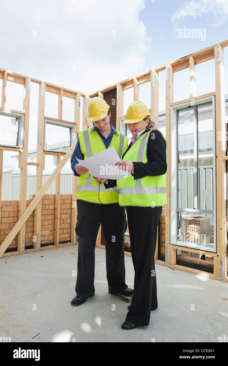 civil engineer and worker discussing issues at the construction site ...
