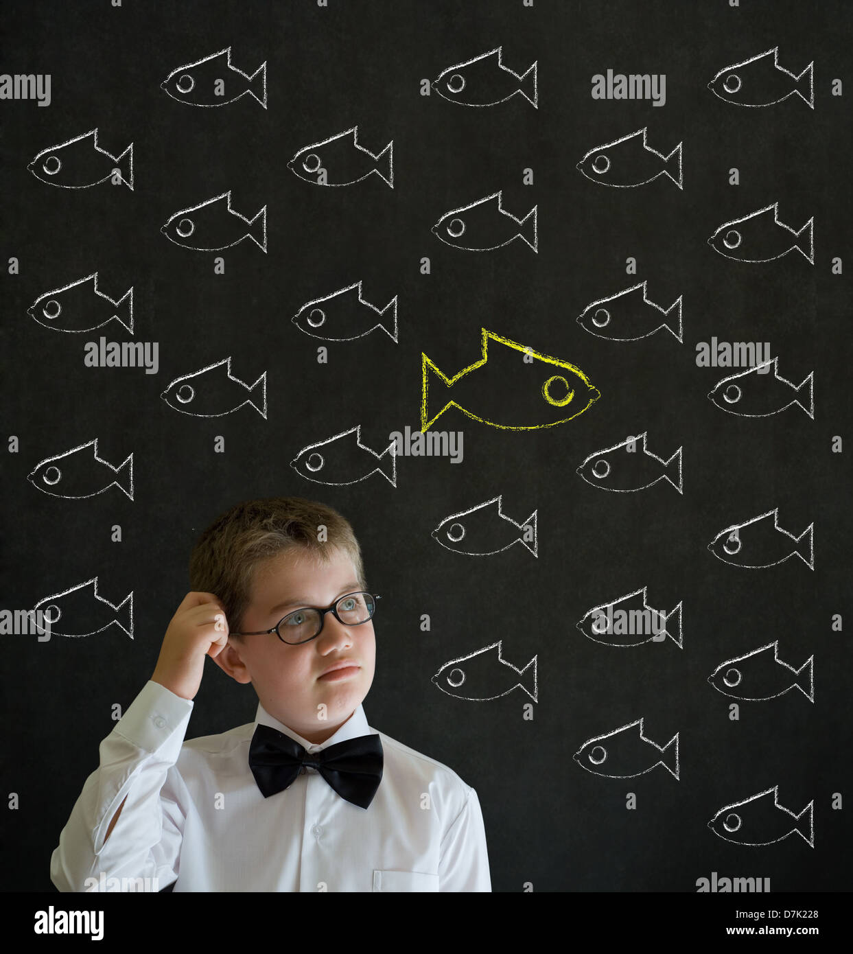 Scratching head thinking boy dressed up as business man with ...