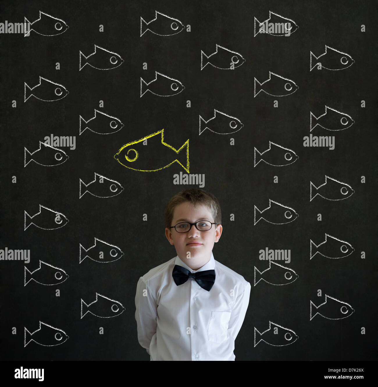 Thinking boy dressed up as business man with independent thinking chalk ...