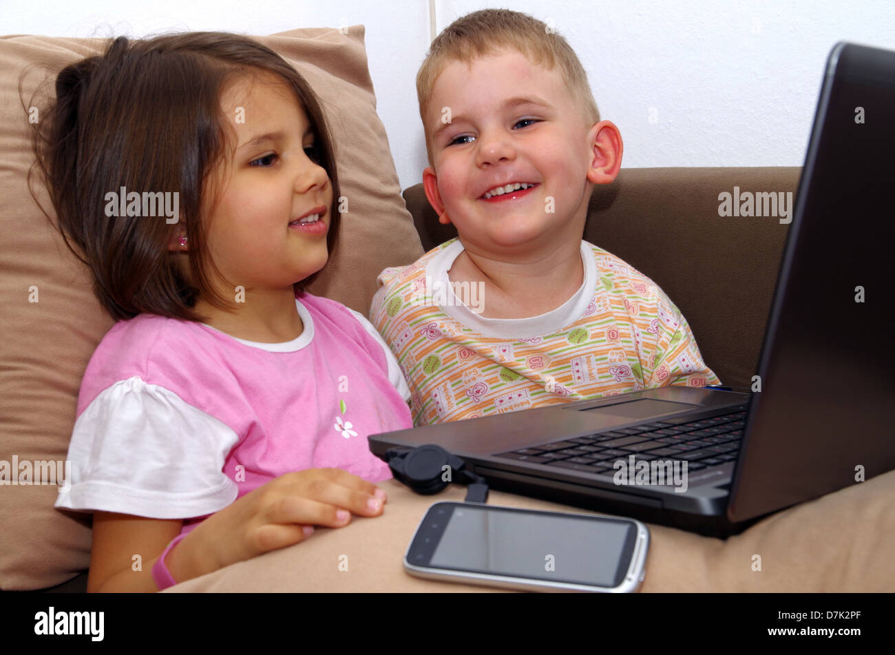 Sister brother working on laptop High Resolution Stock Photography and ...