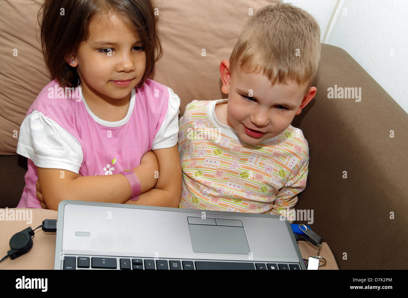 Brother and sister watching a story on a computer Stock Photo - Alamy