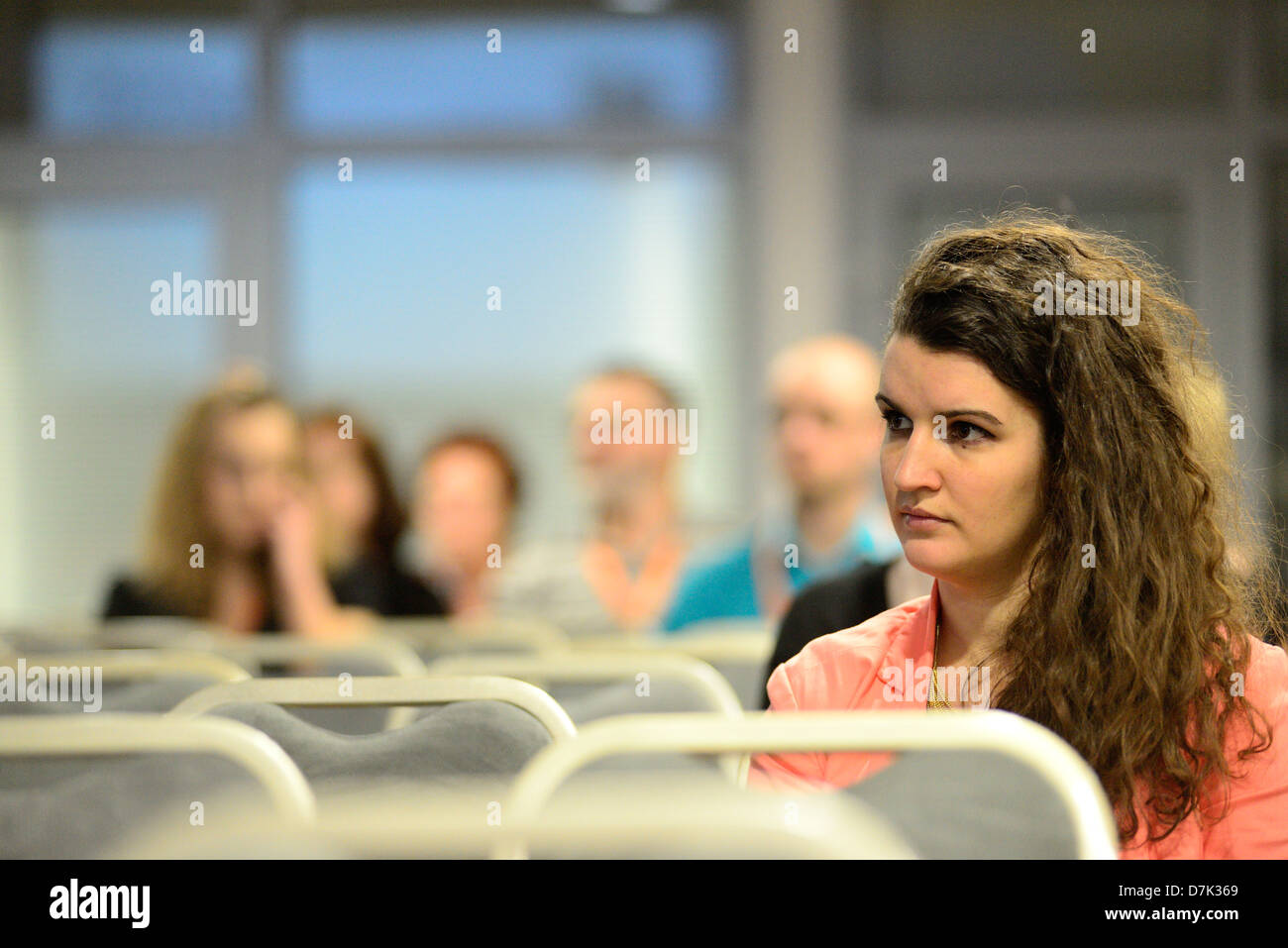 A young woman listening at lecture Stock Photo - Alamy