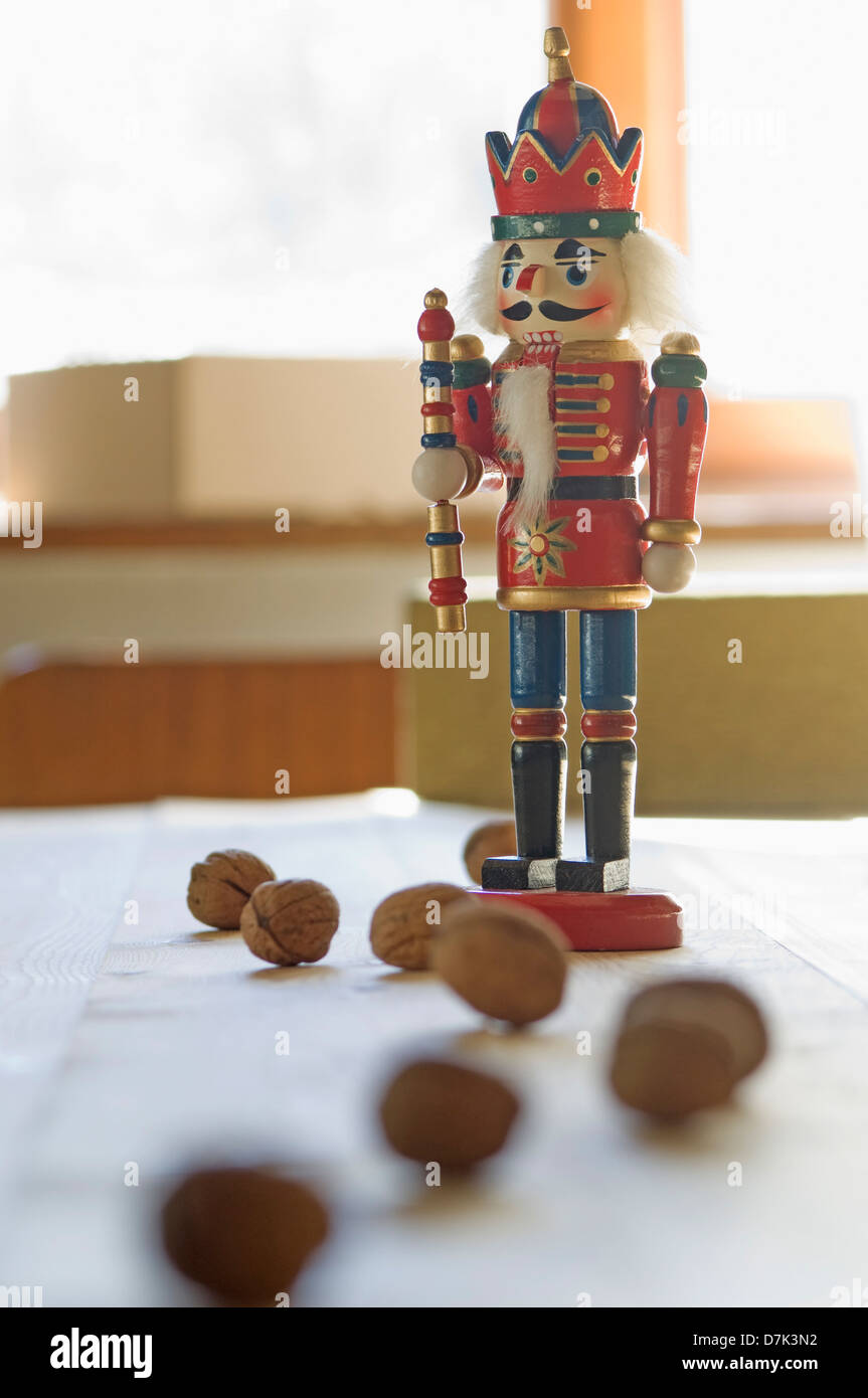 Nutcracker figurine with walnuts on table Stock Photo - Alamy