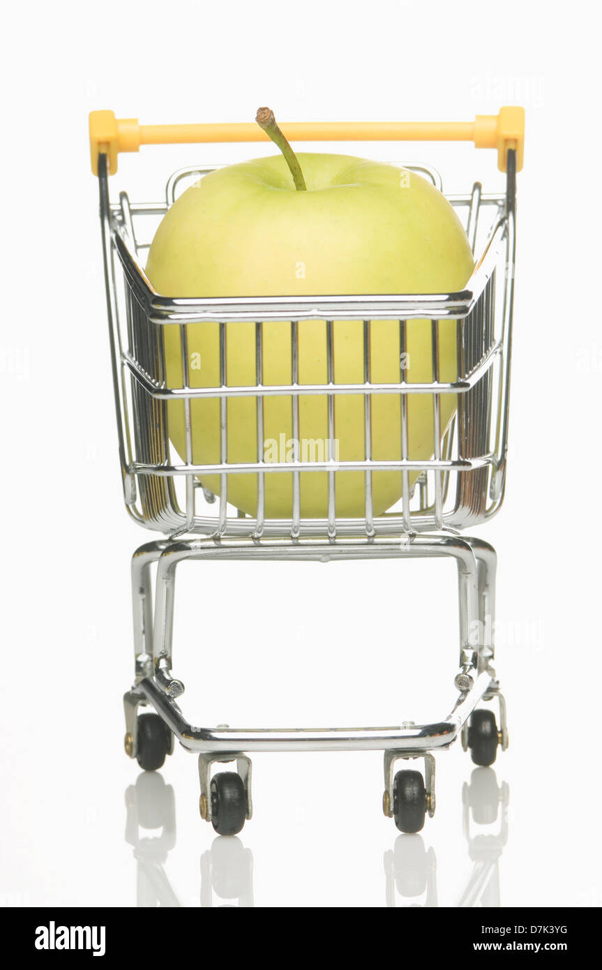 Apple in shopping cart on white background Stock Photo - Alamy