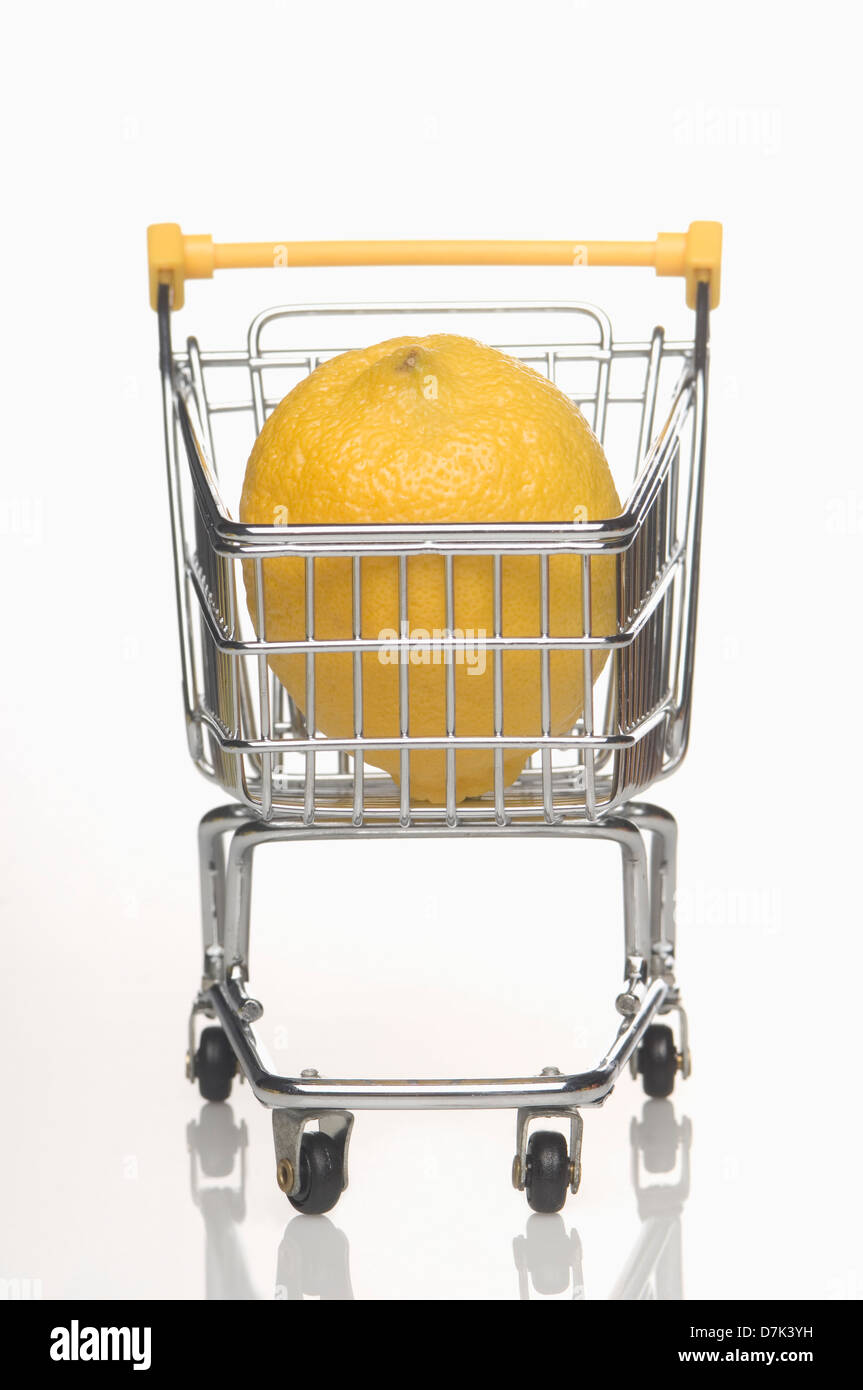 Lemon in shopping cart on white background Stock Photo - Alamy