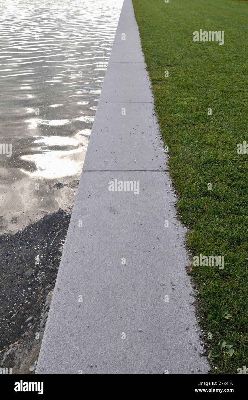 Germany, Edge of water basin with grass lawn Stock Photo - Alamy