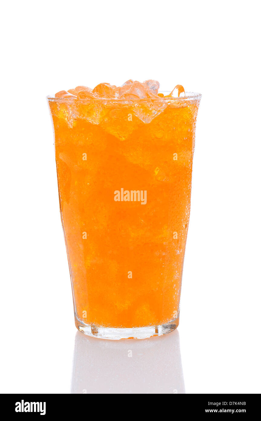 A cold glass of orange soda filled with ice. Vertical format with a ...