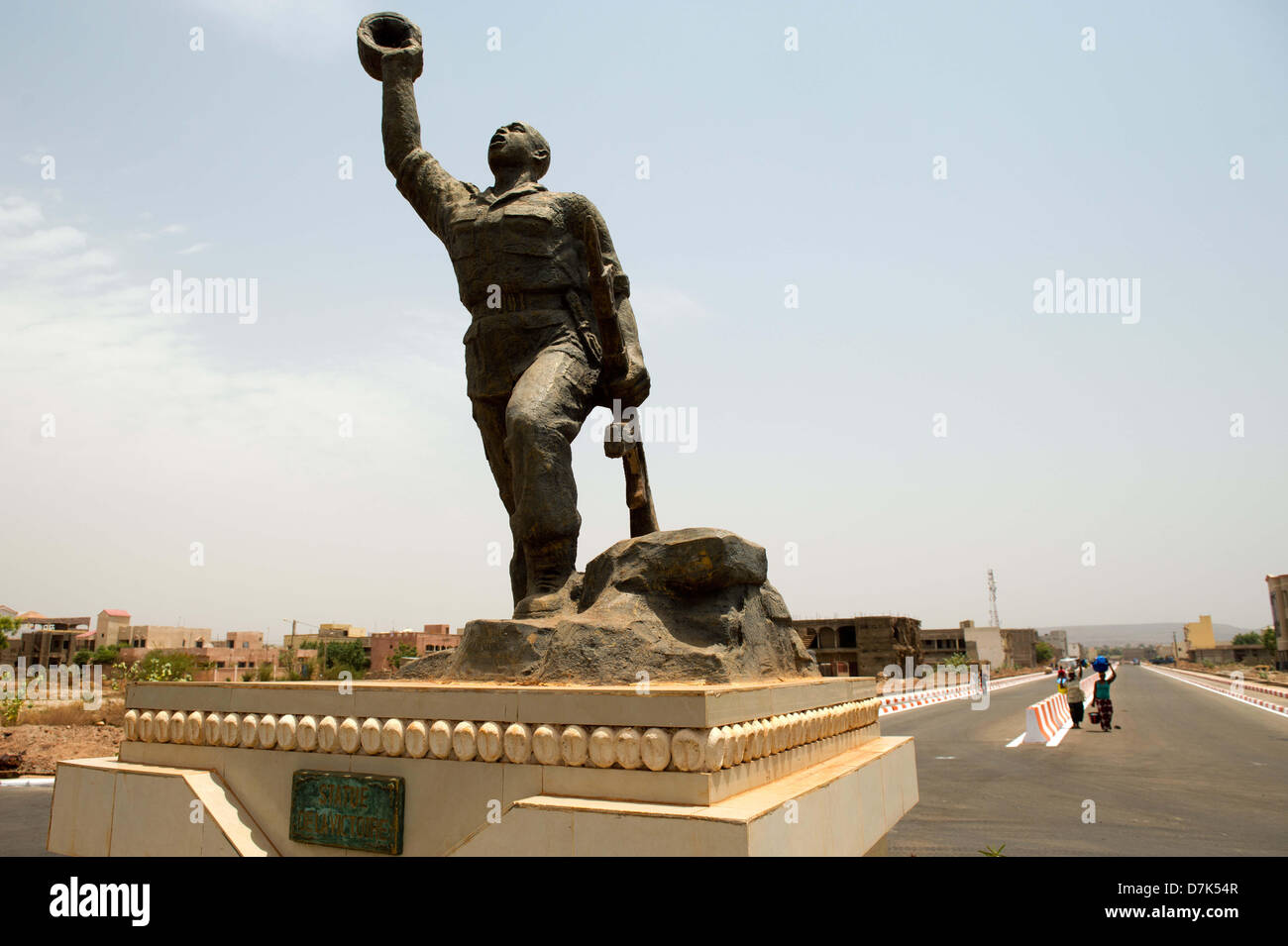 Two women walk past the victory monument of the Malian army in Bamako ...