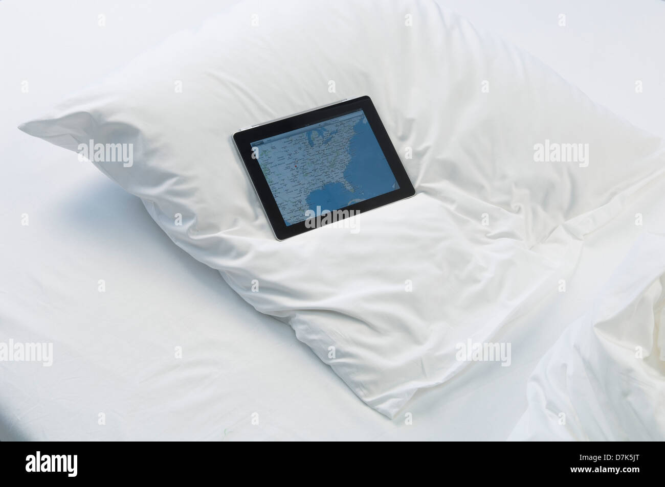 Germany, Digital tablet with world map on white pillow Stock Photo - Alamy