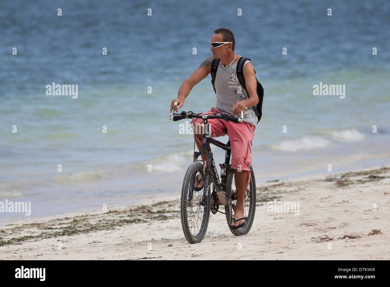 A tourist riding a bicycle in Boracay, Philippines Stock Photo - Alamy