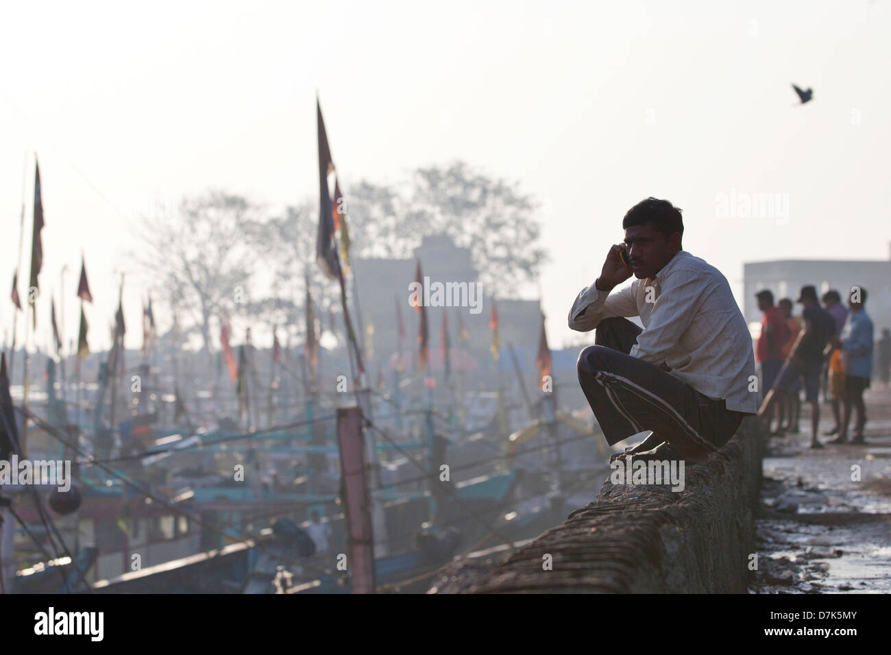 A Crouching man at The Sassoon Docks in Mumbai, India Stock Photo - Alamy