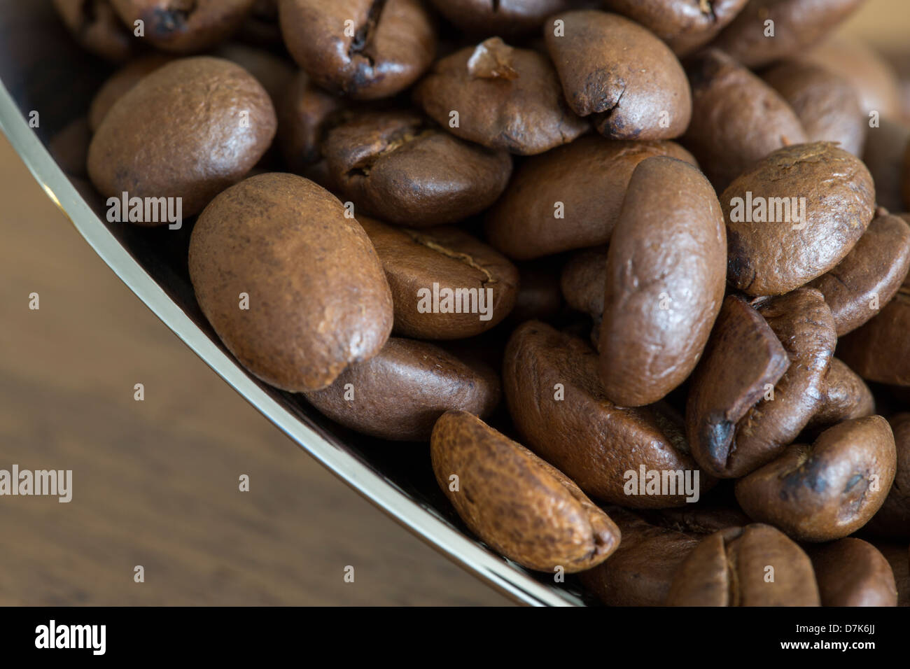 A close up of a silver spoon filled with coffee beans Stock Photo - Alamy