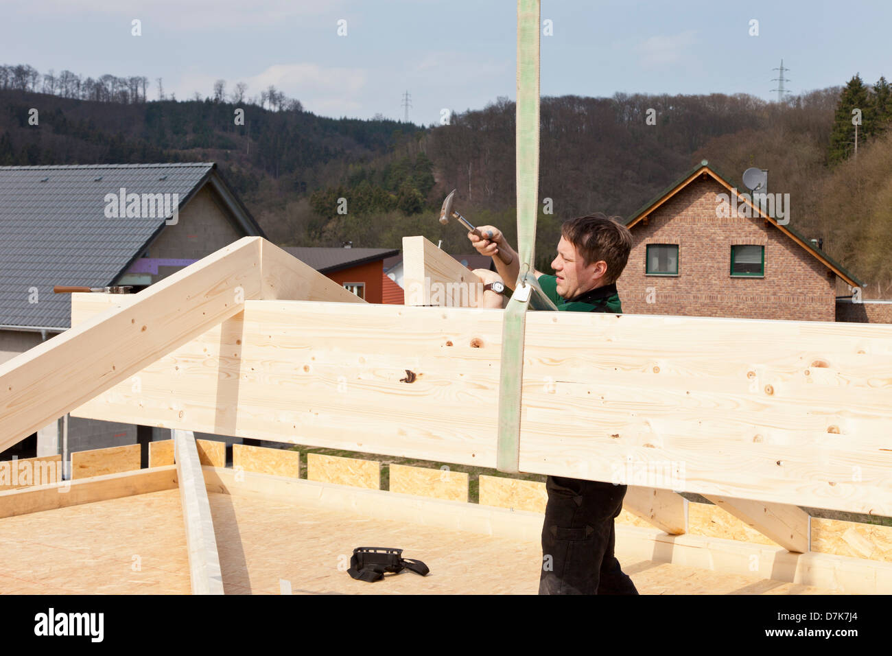 Europe, Germany, Rhineland Palantinate, Man assembling ridge purlin ...