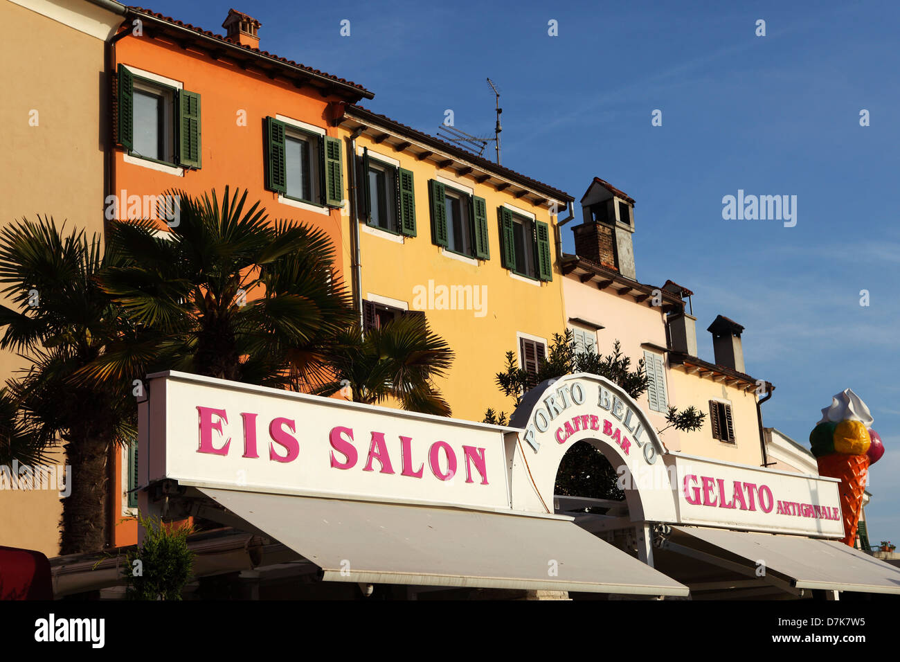 Pastel coloured housing by a cafe and ice cream parlour at the harbour ...