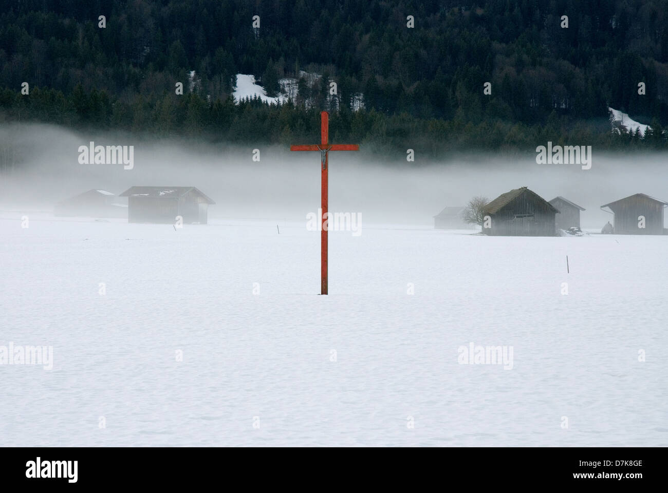 Oberstdorf, Germany, crucifix and huts in a field in the valley of ...