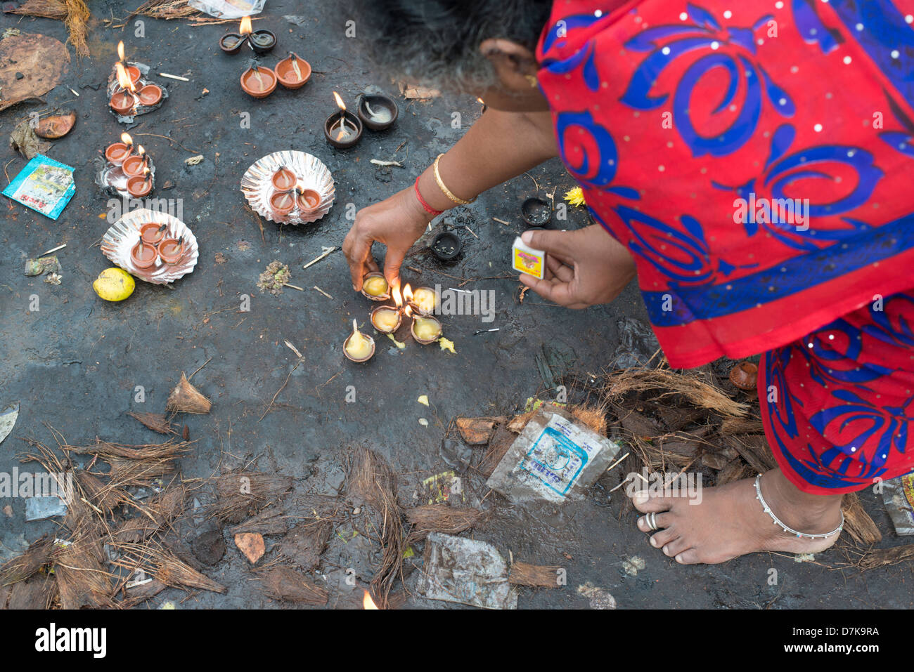 A Hindu devotee lights ghee lamps at the Arunachaleswara Temple in ...