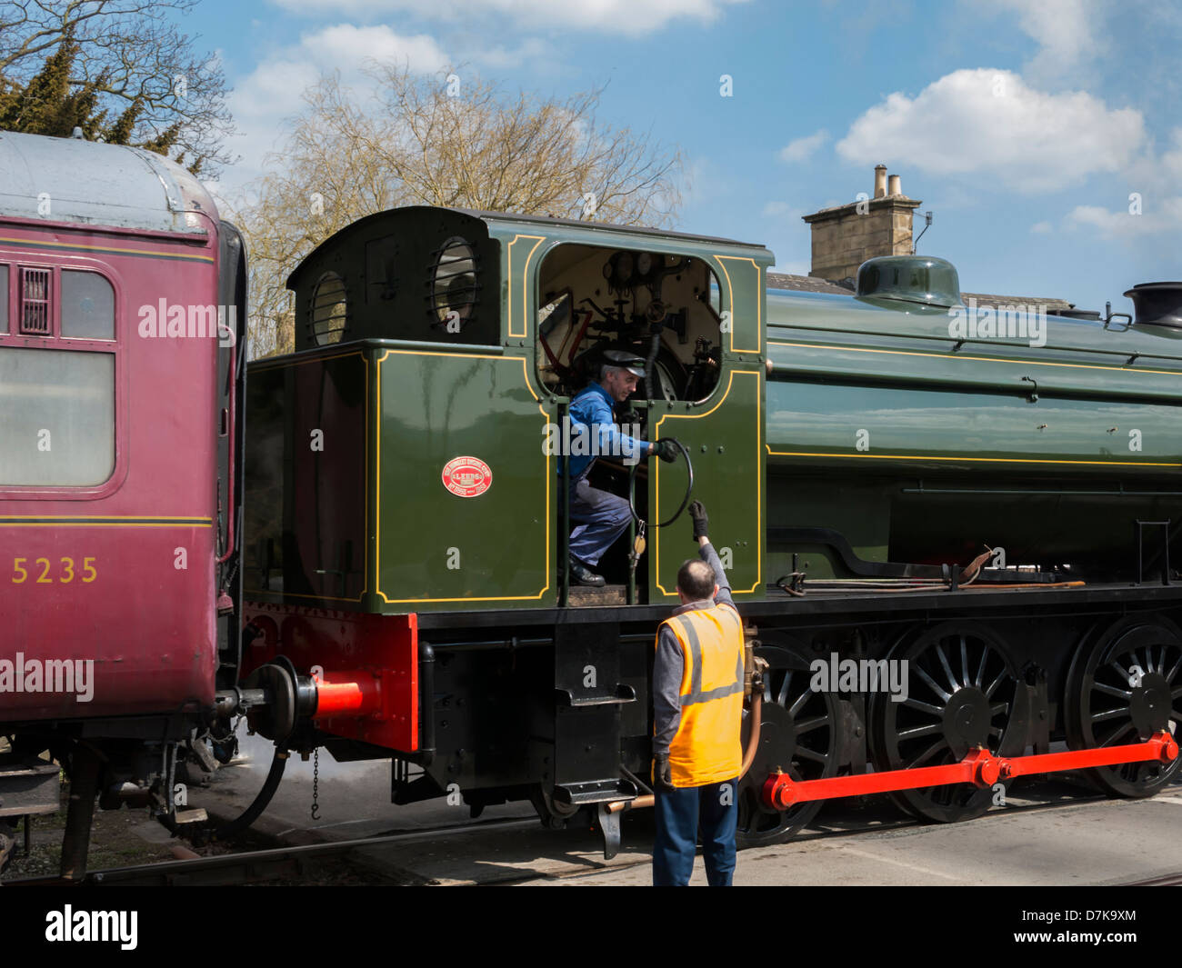 Signalman handing keys to train driver at Darley Dale railway station ...