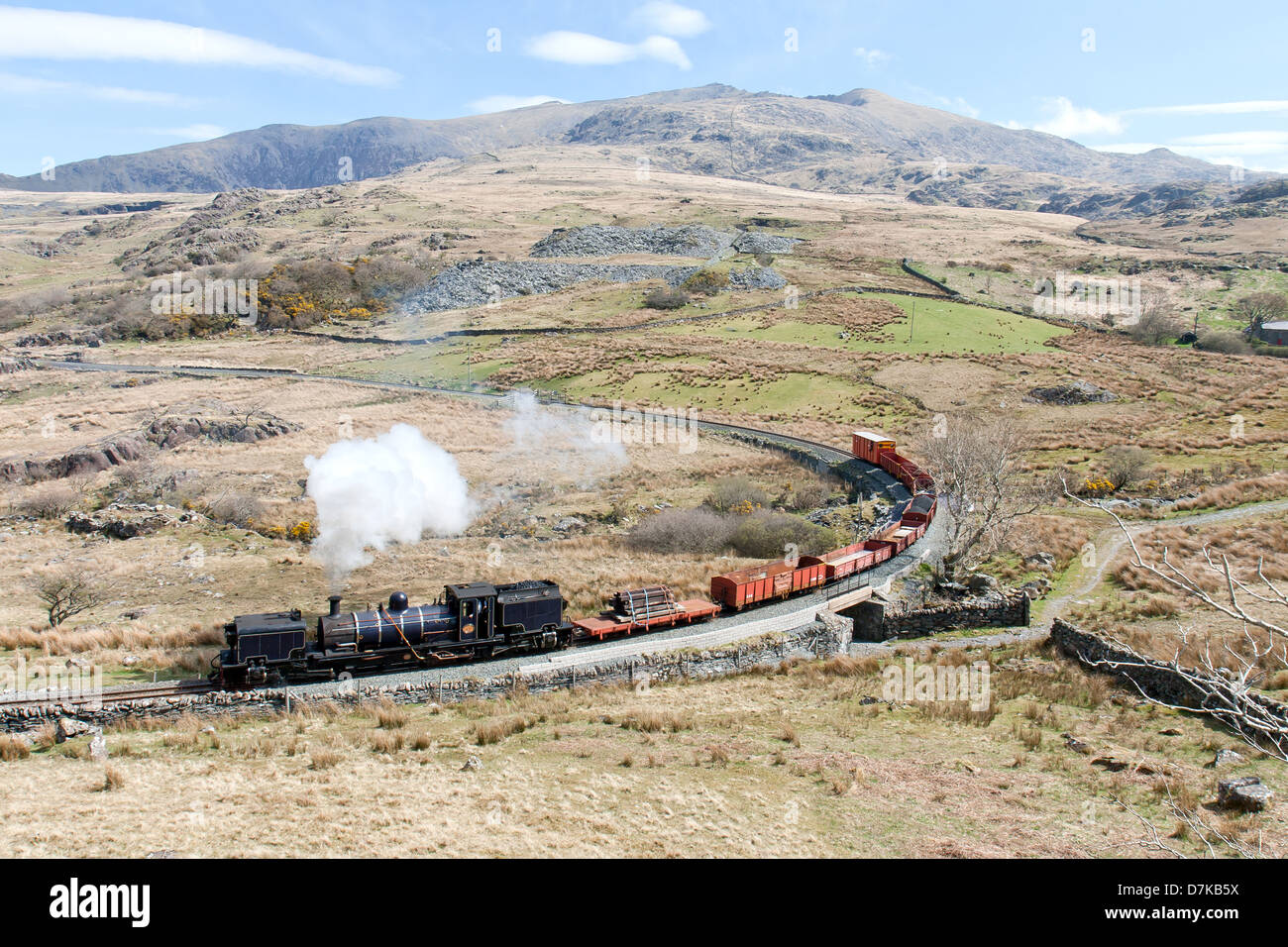 A steam locomotive pulling a freight train on the Welsh Highland Line ...