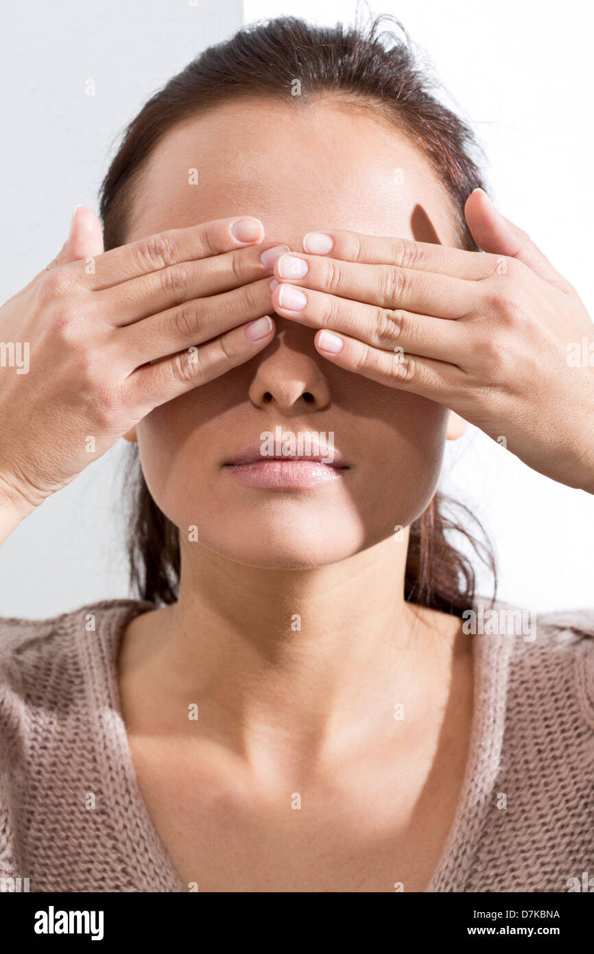 Portrait of young woman covering eyes Stock Photo - Alamy