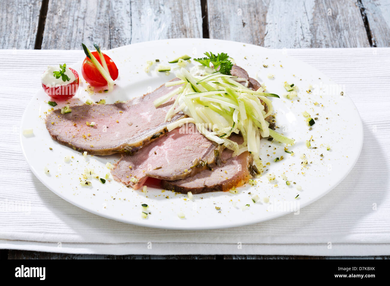 Garnished cold roast beef on plate, close up Stock Photo - Alamy