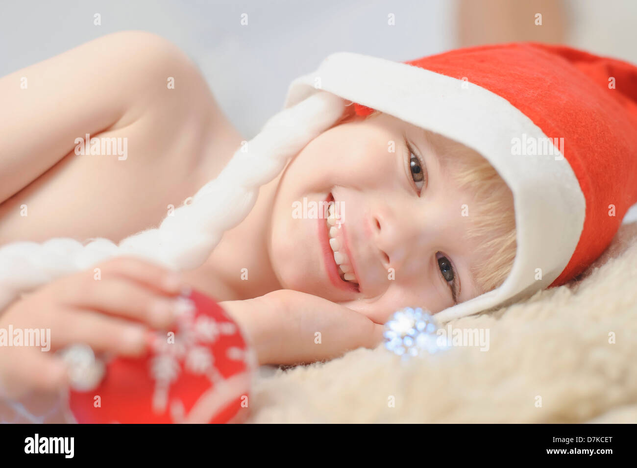 Boy holding christmas bauble, smiling, portrait Stock Photo - Alamy