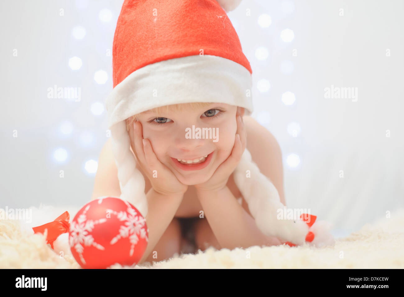 Boy holding christmas bauble, smiling, portrait Stock Photo - Alamy