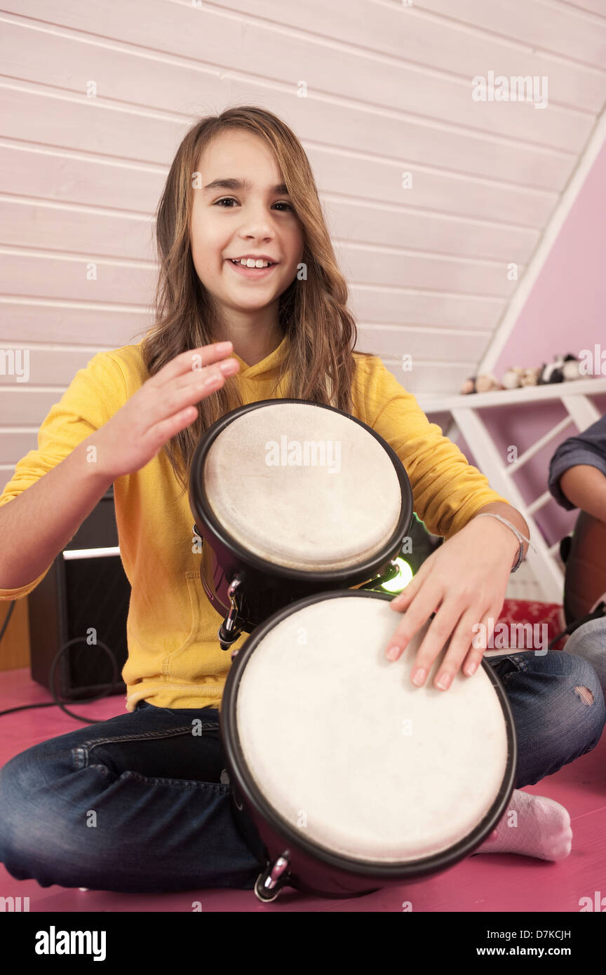Girl playing drums, smiling, portrait Stock Photo - Alamy