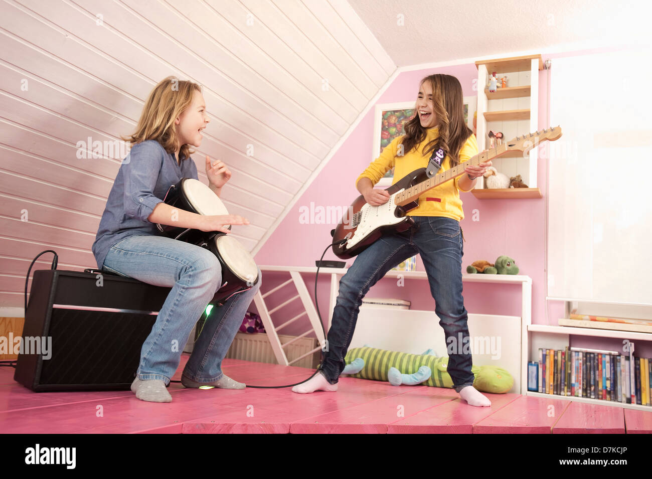 Girls playing guitar and drums, laughing Stock Photo - Alamy